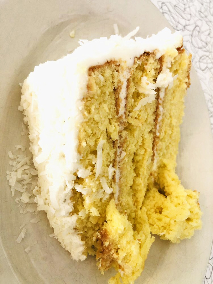 This coconut cake doesn't just satisfy sweet cravings &ndash; it creates them, with moist layers and creamy frosting that locals have been known to drive across town for.