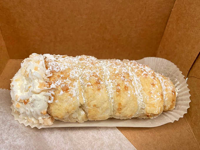 The coconut cream horn gets dusted with powdered sugar and dipped in more coconut, subscribing to the "go big or go home" school of pastry philosophy.