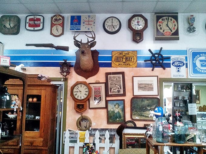 Wall-to-wall nostalgia! Vintage clocks, advertising signs, and a mounted deer head create a perfect snapshot of mid-century American décor.