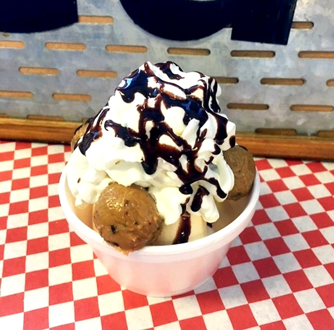 Cookie Dough Sundae: A mountain of vanilla ice cream crowned with whipped cream and chocolate drizzle &ndash; the kind of dessert that makes adults giggle with childlike delight.