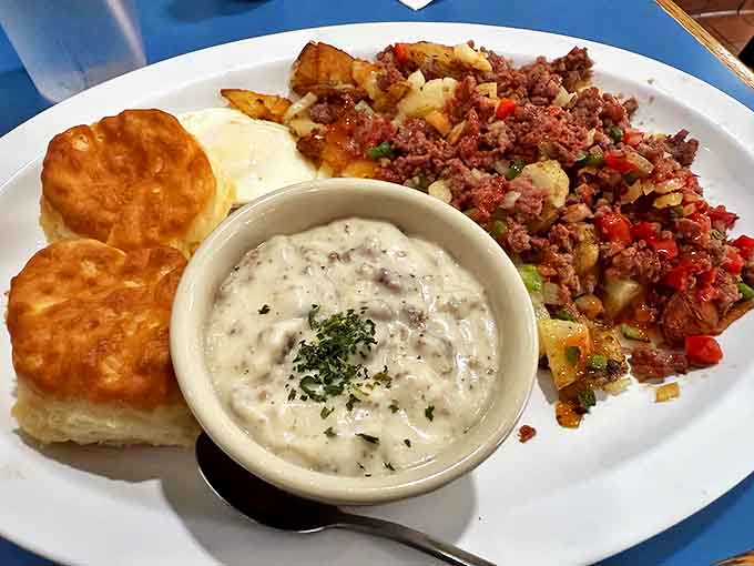 This hearty plate features crispy-edged corned beef hash, fluffy biscuits, and country gravy that could convert any breakfast skeptic.