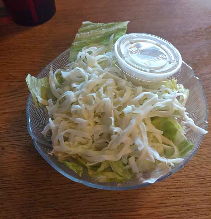 Even the side salad gets respect here, arriving fresh and crisp like it actually matters, because apparently everything does at this place.