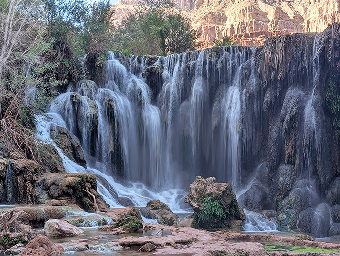Silky smooth: The long exposure effect of falling water creates a dreamy curtain against the rugged canyon backdrop.