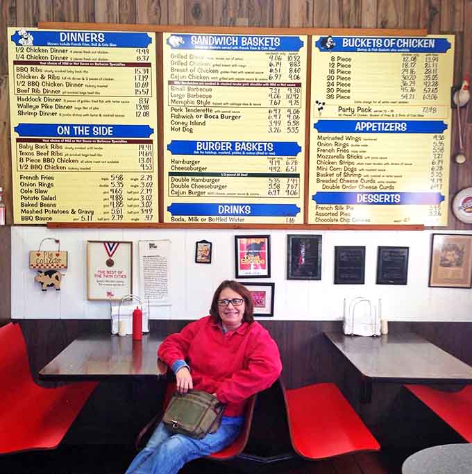 A customer contemplates life's most important question: which donut deserves to come home today? The struggle is deliciously real.