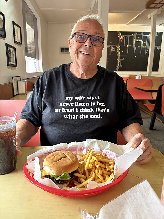 A happy diner shows off the simple pleasure of a perfectly executed burger basket &ndash; his shirt saying what we're all thinking about good advice.