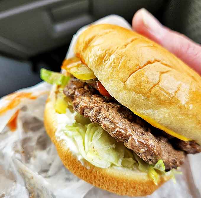 Fresh lettuce and tomato add a pop of color to this classic creation &ndash; like a summer garden harvested directly onto your patty.