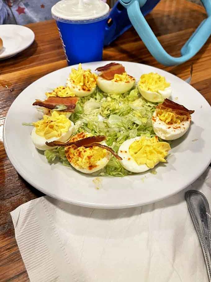 Deviled eggs that prove sometimes the classics don't need reinvention – just perfect execution, a sprinkle of paprika, and bacon's blessing.