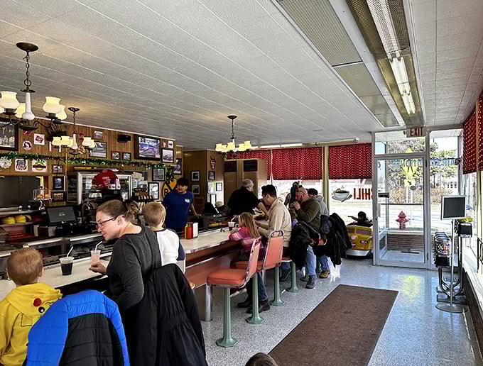 Diners: The counter buzzes with anticipation as patrons of all ages gather, united by the universal language of good food and train-delivered delight.