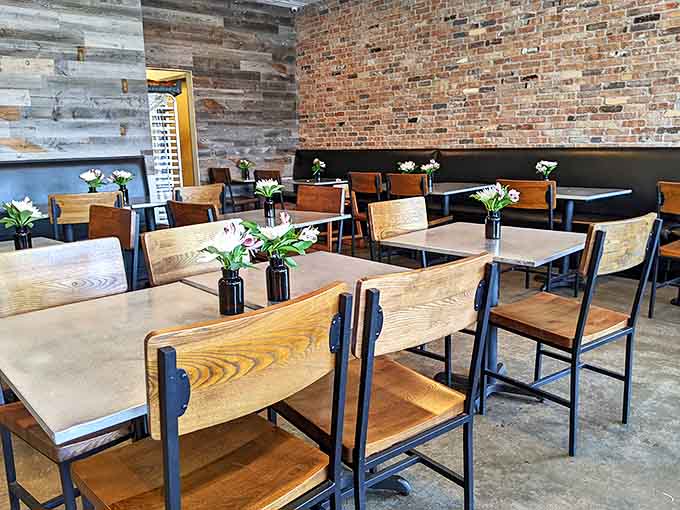 Exposed brick, wooden tables, natural light, this dining room makes you want to cancel your afternoon plans and just stay awhile.