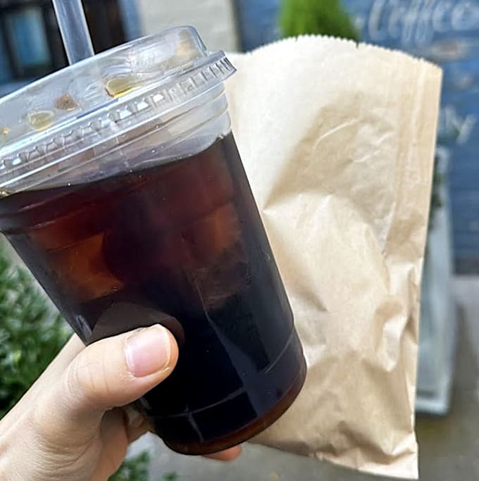 Cold brew and a paper bag of possibilities, the breakfast of champions who know what really matters in life.