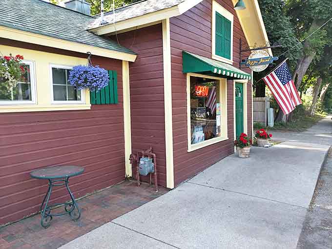 Hanging flower baskets and patriotic flags frame the entrance to this charming pizza cottage that looks more like a storybook home than a restaurant.