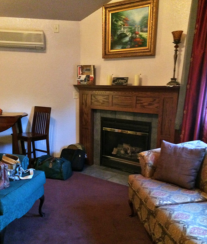 This cozy fireplace corner proves that before Netflix, people gathered around actual fire for entertainment &ndash; and it still works beautifully.