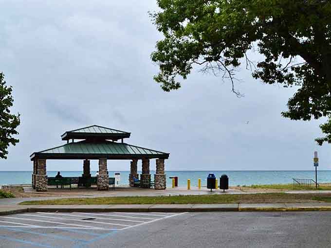 Stone pillars and green metal roofing create a rustic shelter perfect for picnics with a view that rivals five-star restaurants.