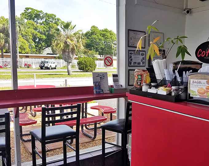 Simple indoor seating invites you to linger over your breakfast while sunlight streams through windows framing views of swaying palms.