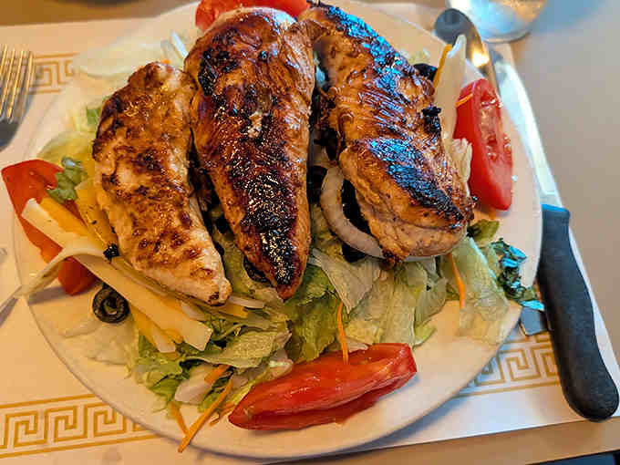The grilled chicken salad offers a moment of virtuous eating at Fred's – though "light fare" still means a portion that could feed a small family.