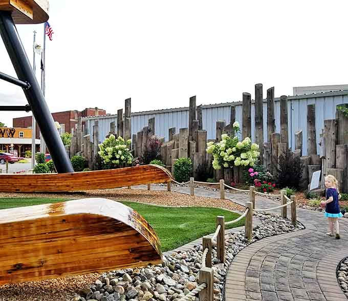 The thoughtfully designed garden area surrounding the chair provides multiple vantage points for capturing this engineering marvel from every angle.