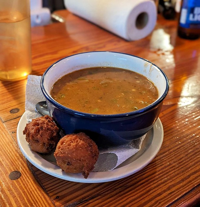 This isn't just gumbo &ndash; it's a deep, rich seafood symphony in a bowl, with hush puppies standing by for the important job of sopping up every last drop.