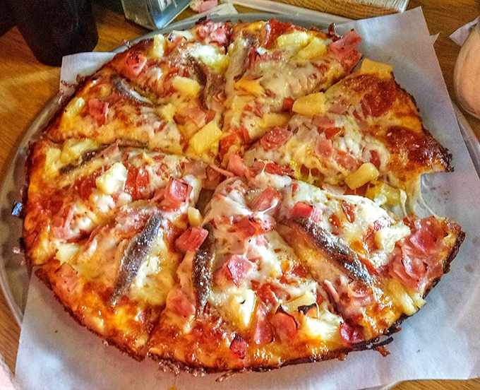 Hawaiian pizza with anchovies? It's the culinary equivalent of wearing socks with sandals, yet somehow, under this historic roof, it works brilliantly.