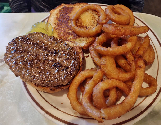 This burger doesn't need trendy toppings or a cutesy name – just quality beef, perfect char, and those legendary onion rings for company.