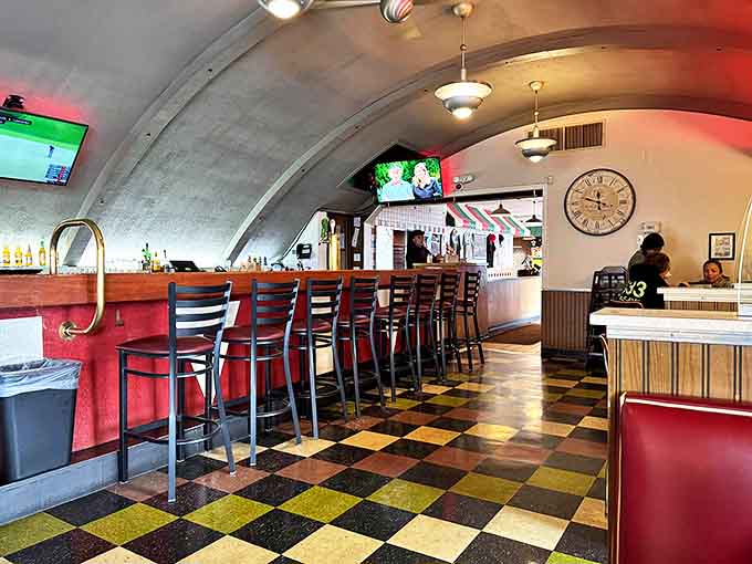 The narrow walkway between wooden booths feels like a passage through time, where every surface tells a story of American confectionery tradition.