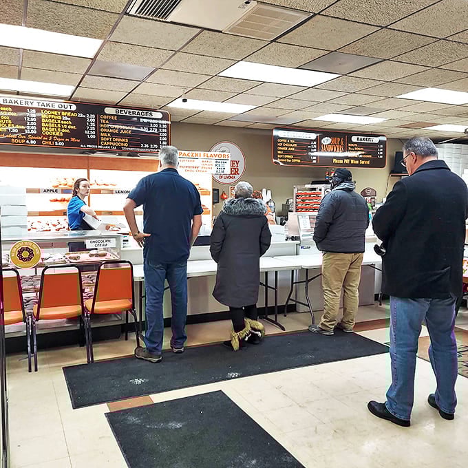 The morning line forms at the counter – a diverse democracy united by the universal language of "I need something sweet and I need it now."