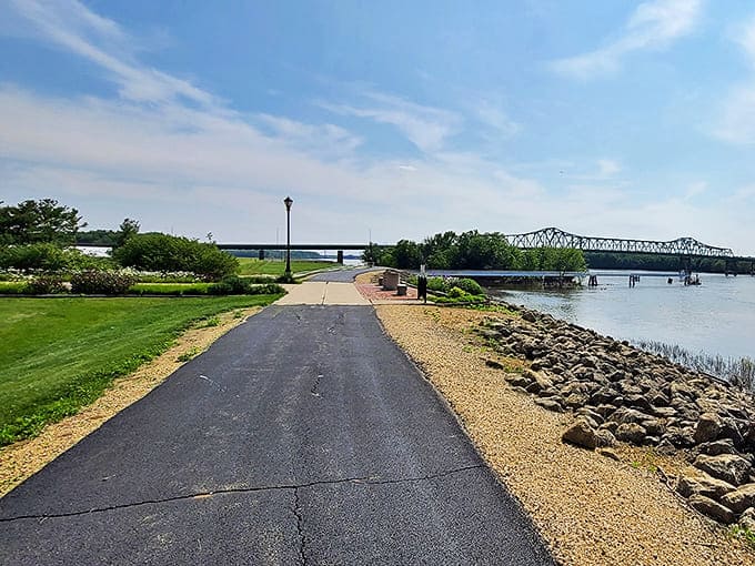 Morning light bathes the Mississippi riverfront trail, where joggers and dreamers find their rhythm alongside the flowing water.