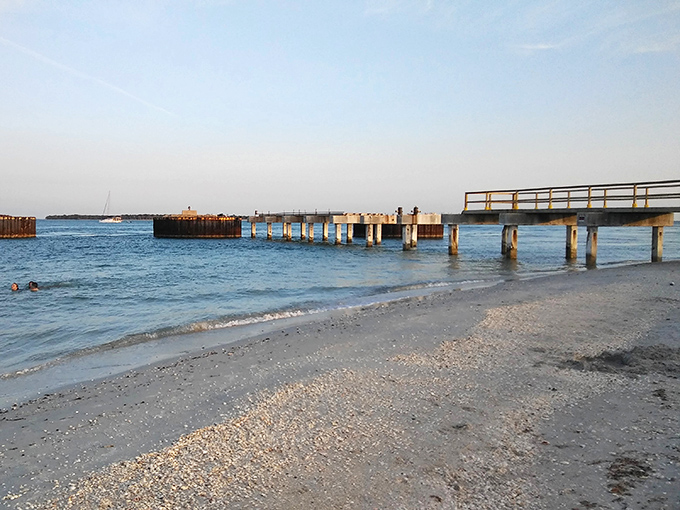 The weathered pier stretches into the gentle waters, a reminder of the area's busy past as a phosphate shipping port.