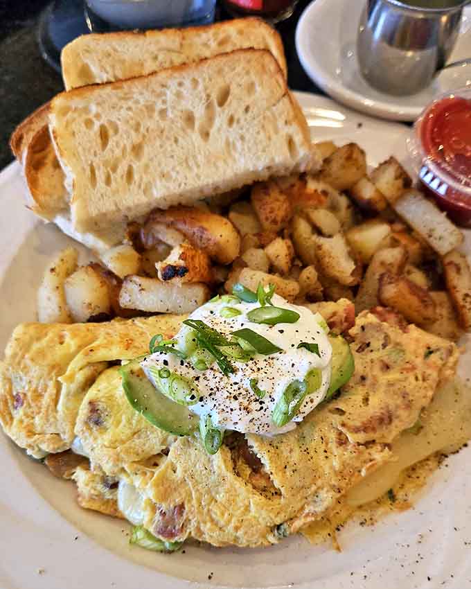 That omelet is stuffed with fresh ingredients and looks fluffy enough to double as a pillow, if pillows were delicious.