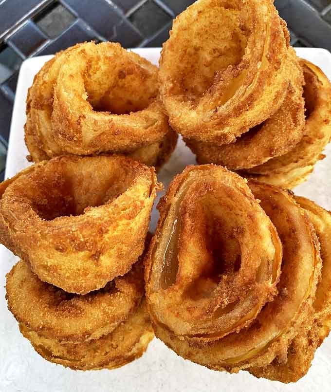 Onion rings that achieve the impossible: shatteringly crisp exteriors protecting sweet, tender onion that doesn't slide out with the first bite. Culinary engineering at its finest.
