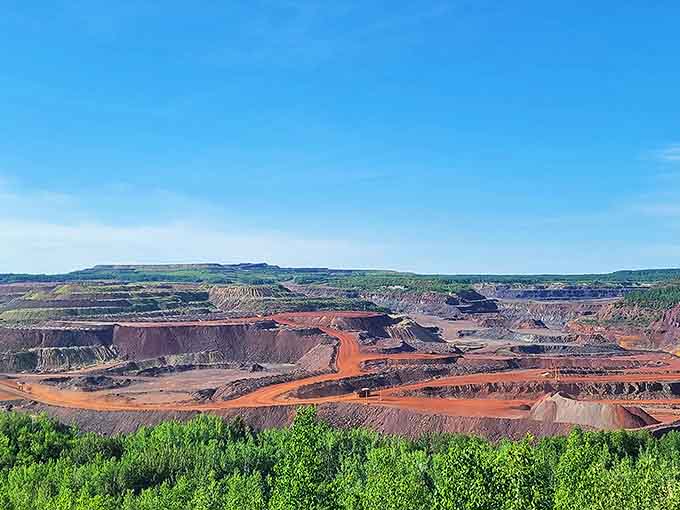 The raw power of human engineering revealed &ndash; terraced mining operations carve into the earth while creating an unexpectedly beautiful industrial landscape.