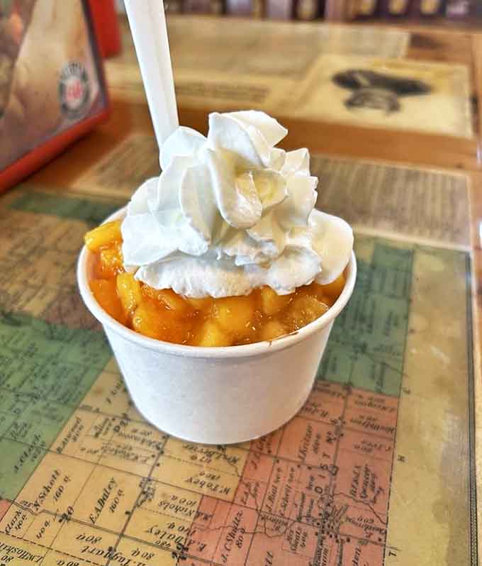 A peach cobbler sundae that bridges the gap between summer and comfort food &ndash; warm fruit, cold ice cream, and the kind of simple pleasure that makes you forget your phone exists.