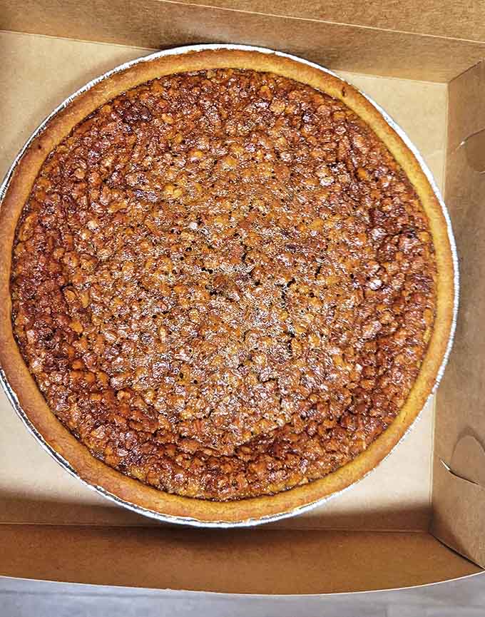 This isn't just pecan pie – it's Southern comfort in a tin, with a filling that strikes the perfect balance between gooey and structured.