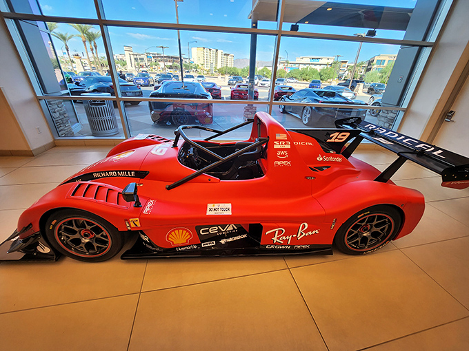 This crimson racing prototype looks ready to pounce, its aerodynamic body designed by wind tunnels and dreams of checkered flags.
