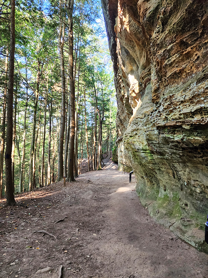 The trail hugs massive rock formations, carved by time and elements. Walking here feels like being a footnote in Earth's autobiography.