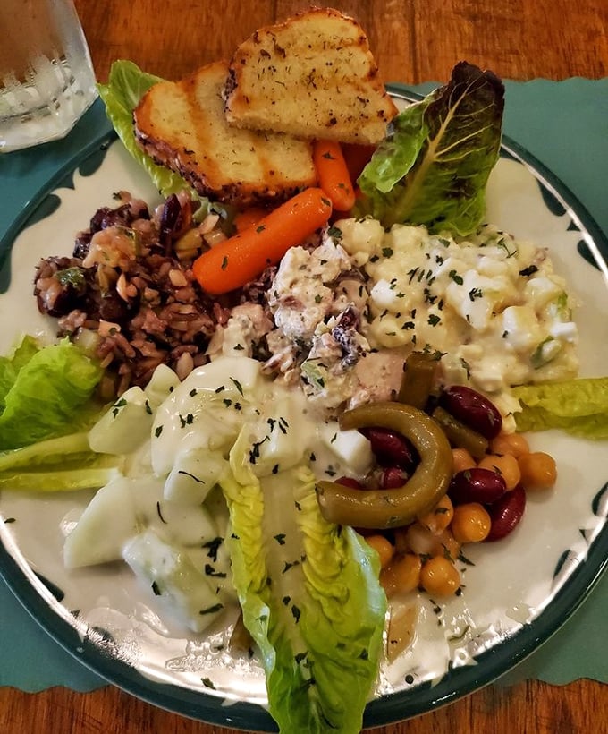 The sampler platter showcases the kitchen's versatility &ndash; house-made salads nestled alongside fresh vegetables and artisan bread that's worth every carb.