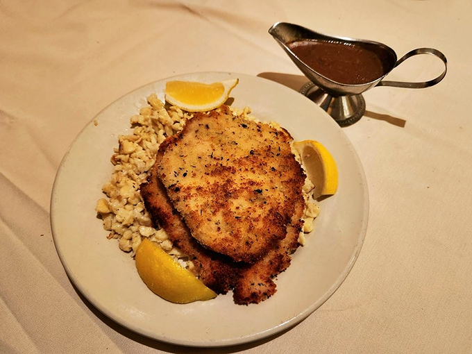 Crispy, golden schnitzel with sp&auml;tzle and lemon, proving that sometimes the simplest preparations yield the most satisfying results.