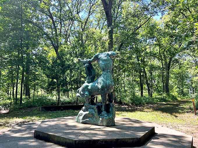 A bronze centaur rears dramatically against the woodland backdrop, proving that mythological creatures appreciate good landscaping as much as anyone.