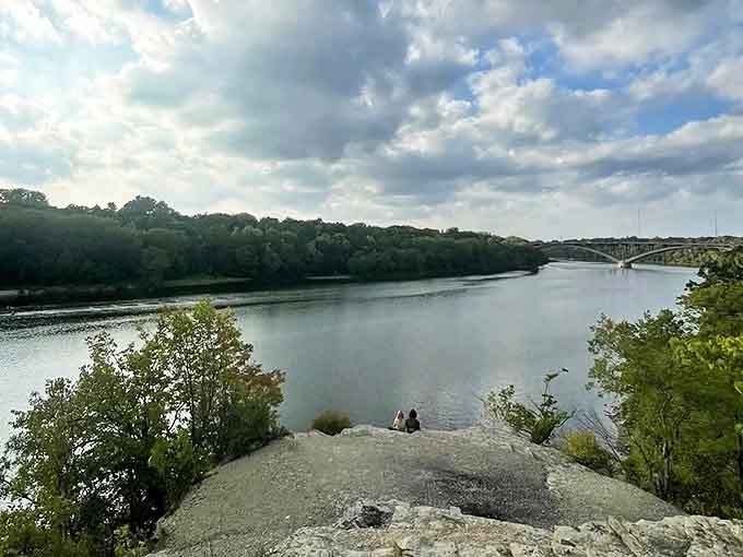 The Ford Parkway Bridge stands as a silent sentinel over the Mississippi, connecting the twin cities while Shadow Falls Park keeps its secrets below.