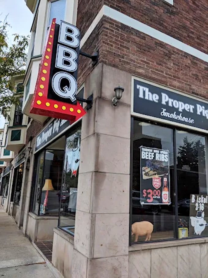 A bold BBQ sign marks the entrance to a neighborhood smokehouse, drawing passersby in with classic roadside charm.