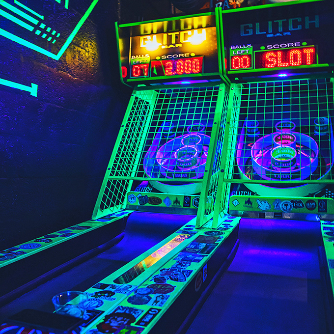 Skee-Ball machines light up with neon brilliance, offering the timeless joy of rolling balls up ramps for tickets &ndash; except now you're old enough for beer.