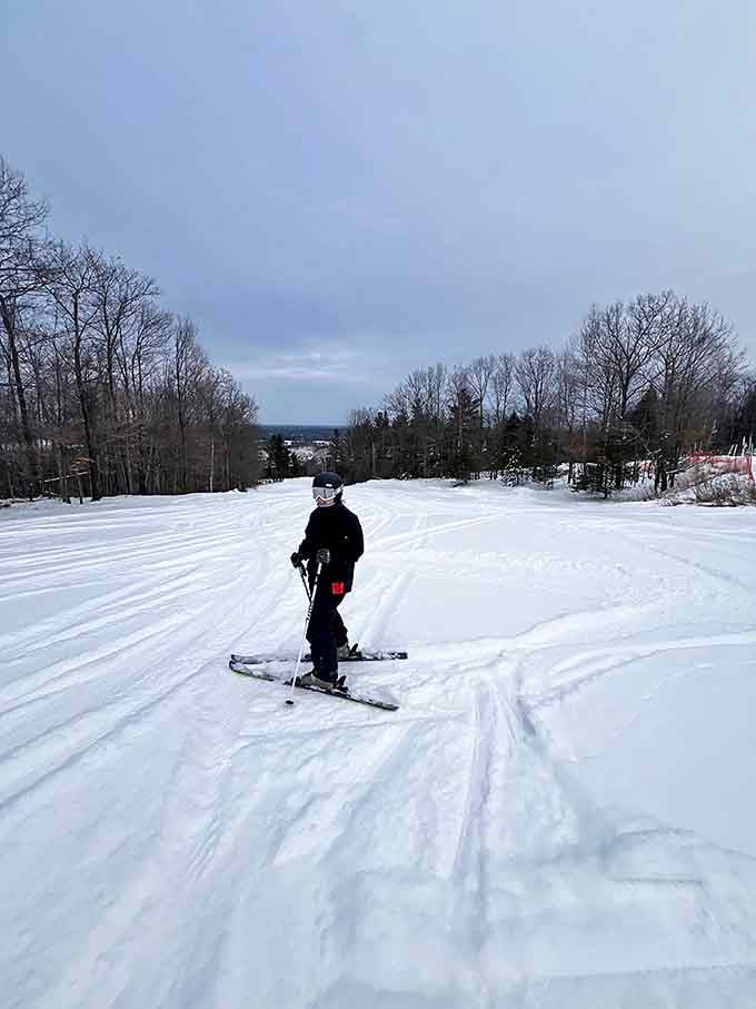 Winter transforms Norway Mountain into a powder playground where families create memories against a backdrop of endless Northwoods panoramas.