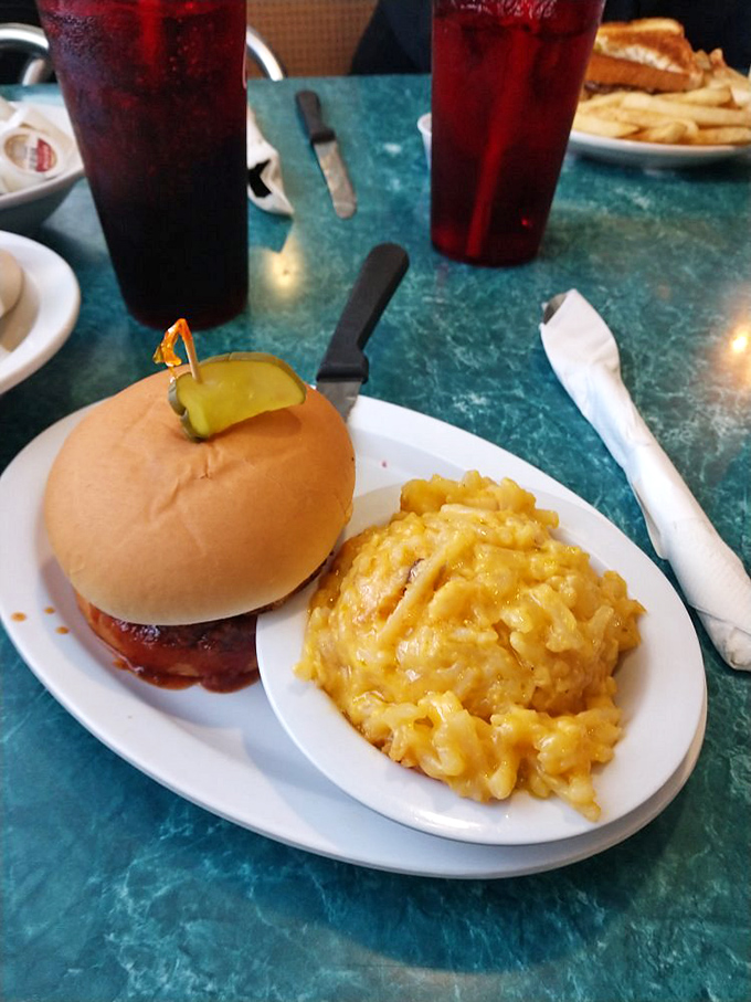 The sloppy joe that finally redeems every disappointing cafeteria memory from your childhood, served with perfectly golden onion rings.