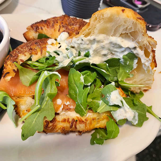 This smoked salmon sandwich with its pillowy bread and fresh greens makes lunchtime feel like a special occasion rather than a midday obligation.