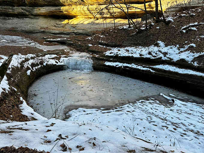 Winter transforms ordinary puddles into icy mirrors, reflecting the golden glow of sunlight on sandstone &ndash; nature's own art installation.