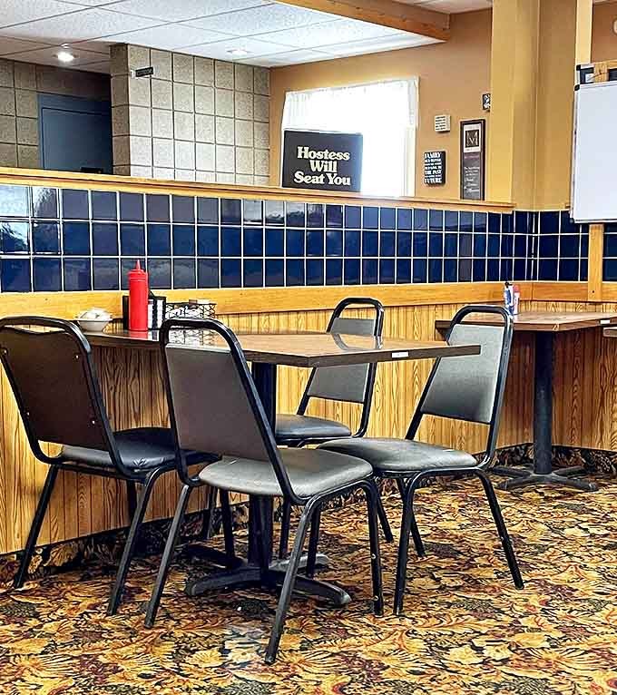 Booths lined with wood and blue tile create that classic diner aesthetic where conversations flow as freely as the coffee refills.