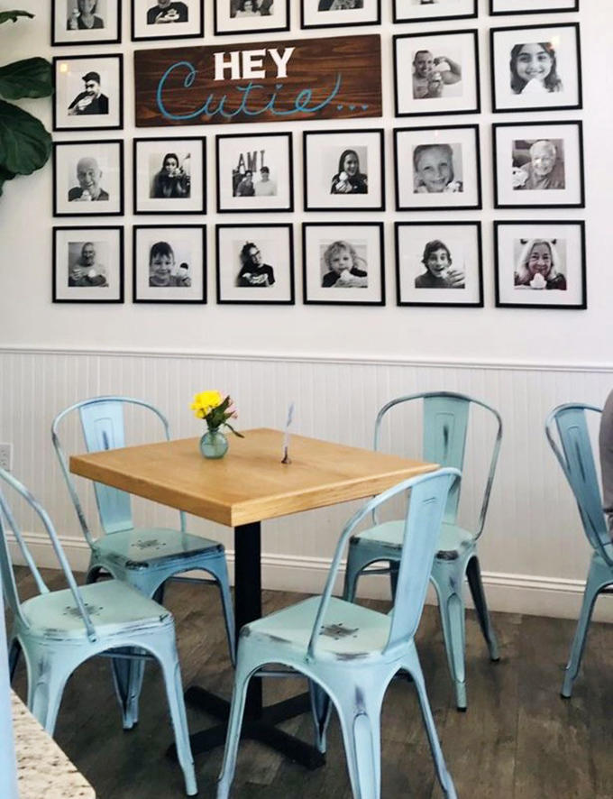 The "Hey Cutie" wall creates an instant community of smiling faces, while those blue chairs practically beg you to sit down and stay awhile.