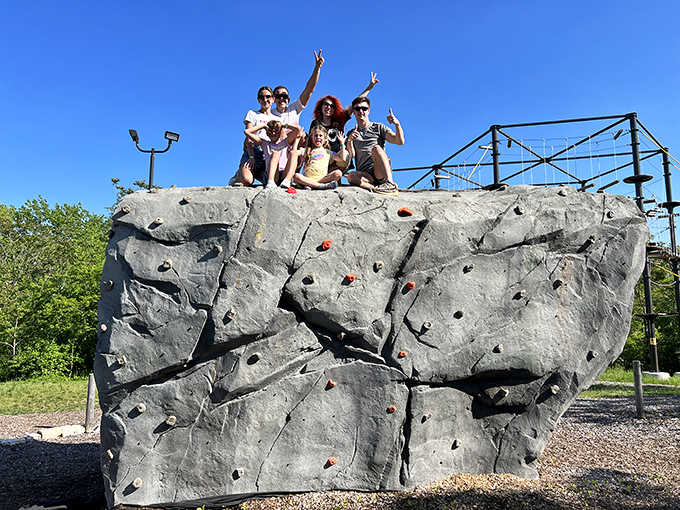 Victory poses atop the climbing wall – the universal language of "I'm terrified but pretending I do this every weekend."