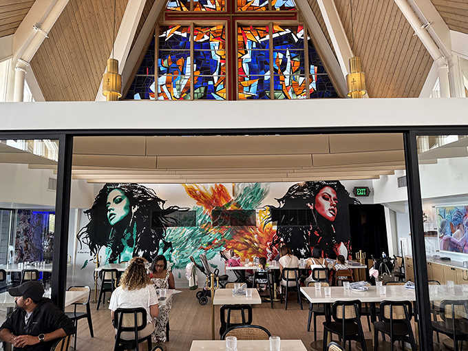 Colorful stained glass windows cast magical light patterns throughout the dining room, creating an atmosphere that feels both sacred and celebratory.