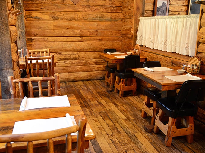 Log walls and rustic furniture create dining spaces that feel like you've stumbled into a particularly delicious frontier homestead.