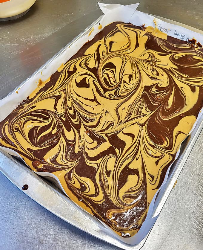 Tiger butter fudge swirls hypnotically, marrying chocolate and peanut butter in a dance so beautiful you'll hesitate before taking that first heavenly bite.